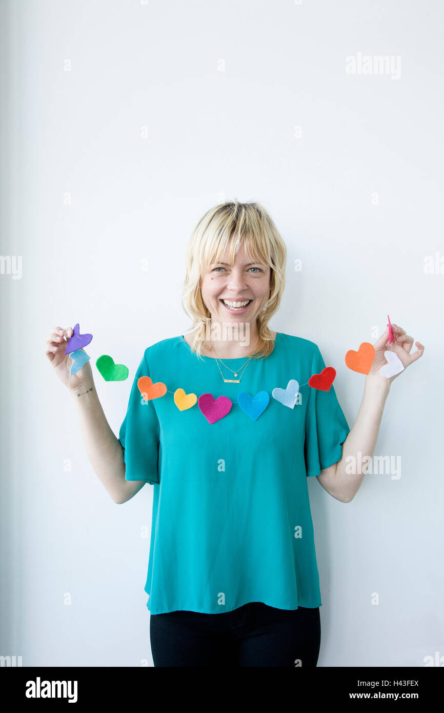Caucasian woman holding string of paper hearts Stock Photo - Alamy