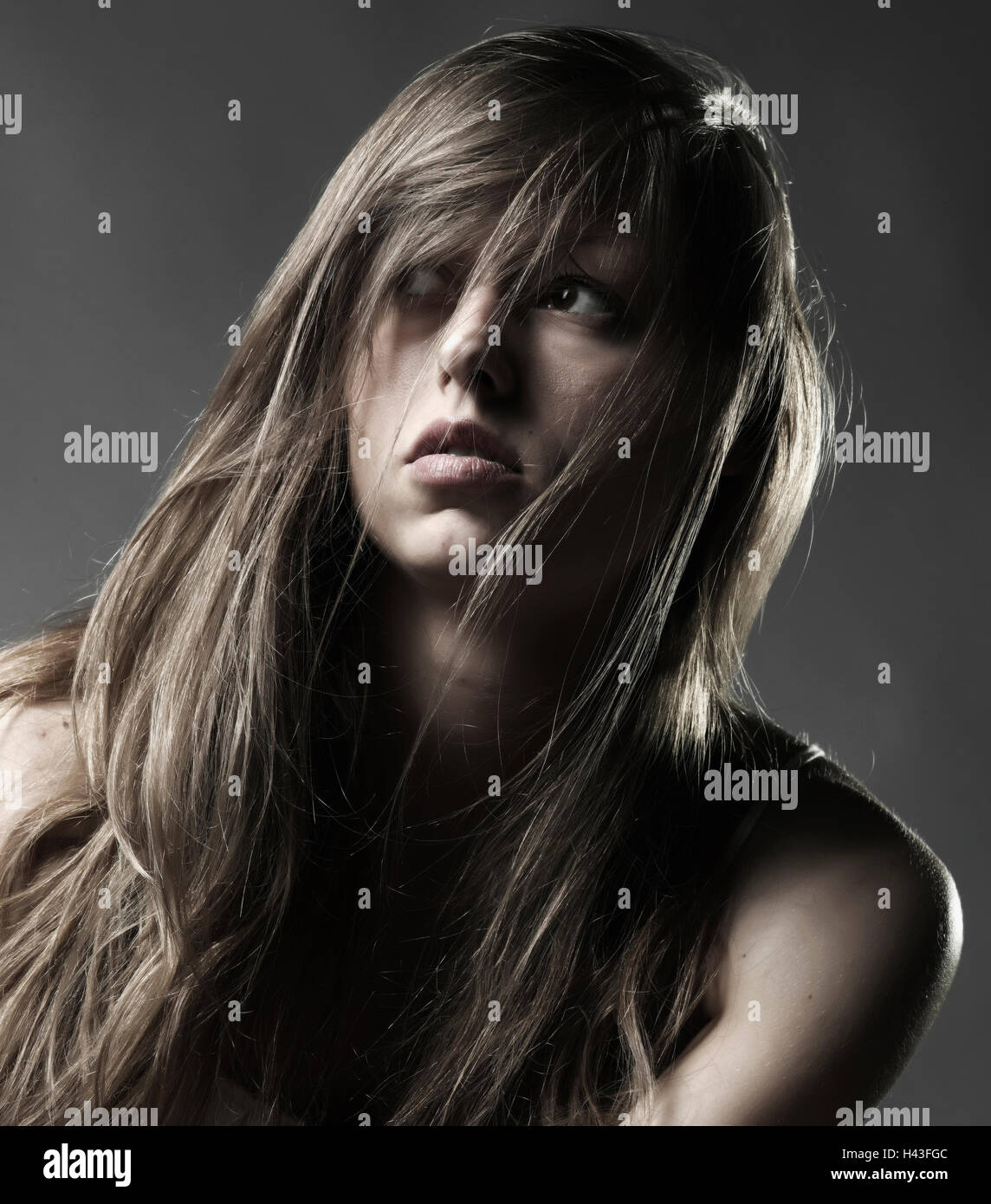 Caucasian woman with long hair looking away Stock Photo - Alamy
