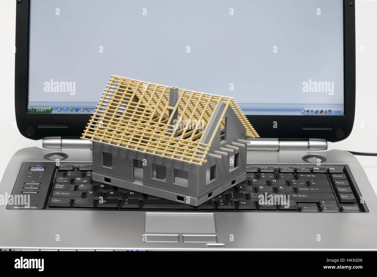 Laptop, house model Stock Photo - Alamy