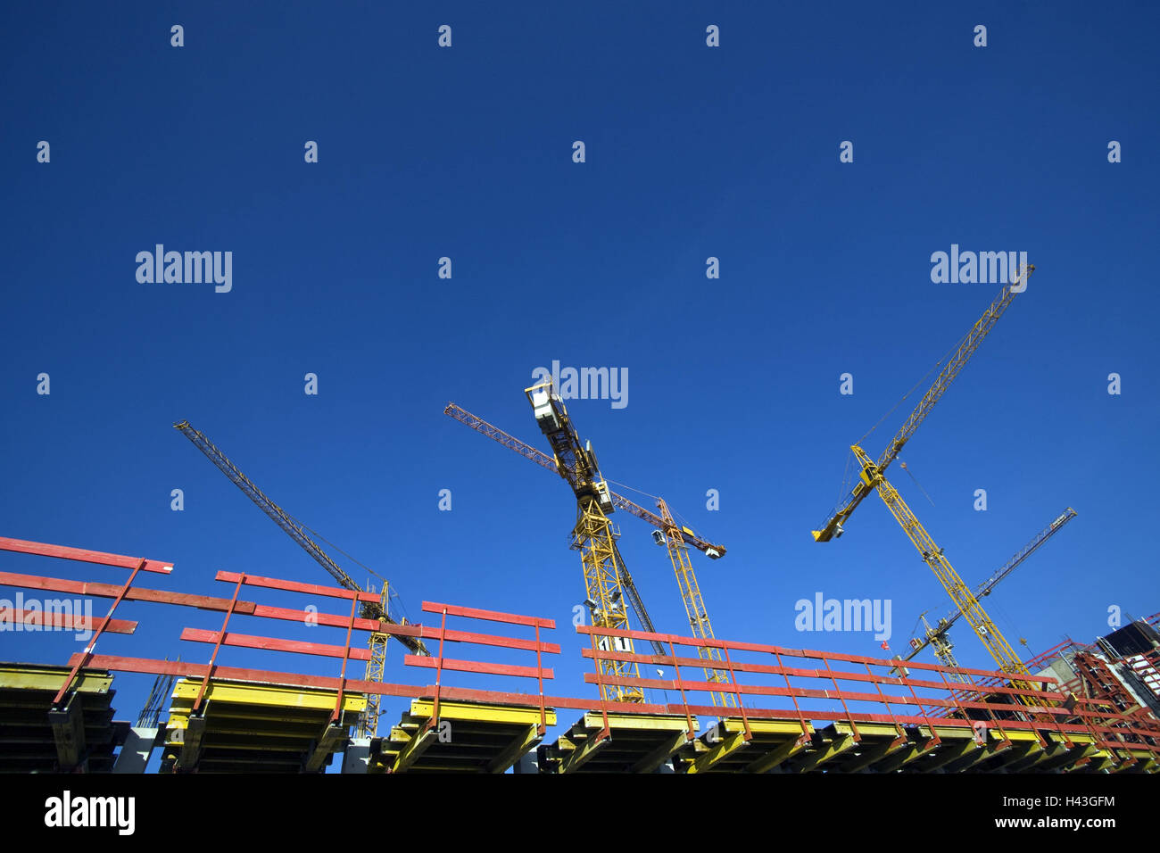 Men at work, construction cranes Stock Photo - Alamy