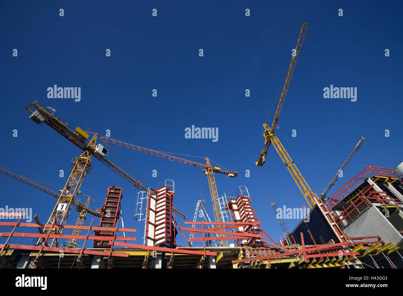 Men at work, construction cranes Stock Photo - Alamy
