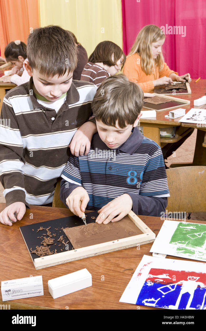 Classroom, art lessons, boy, linocut, concentration Stock Photo - Alamy