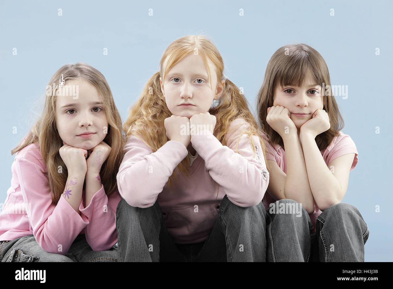 Girls, three, head, rest on, boredom Stock Photo - Alamy