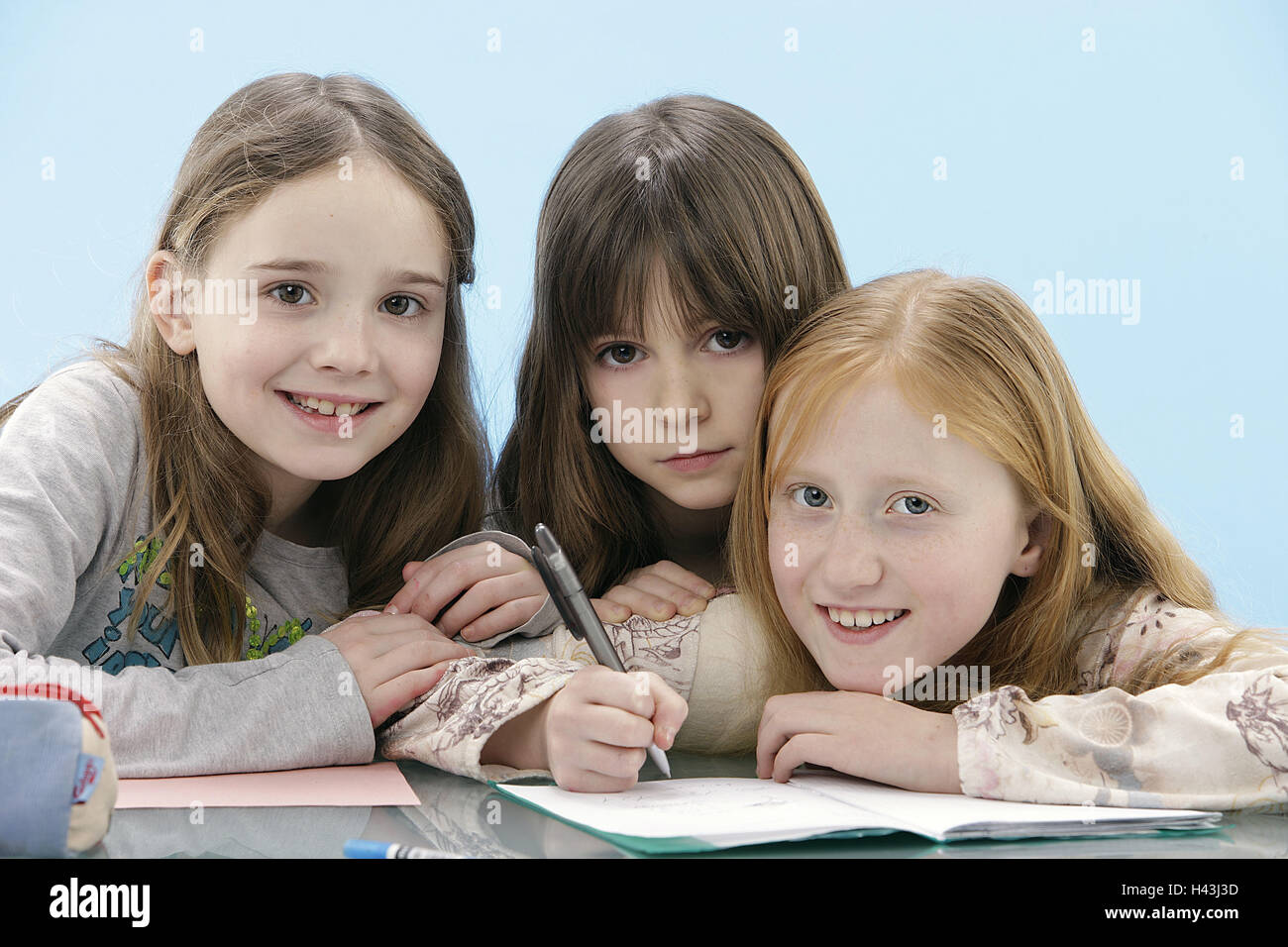 Girls, three, homework, write, together Stock Photo - Alamy