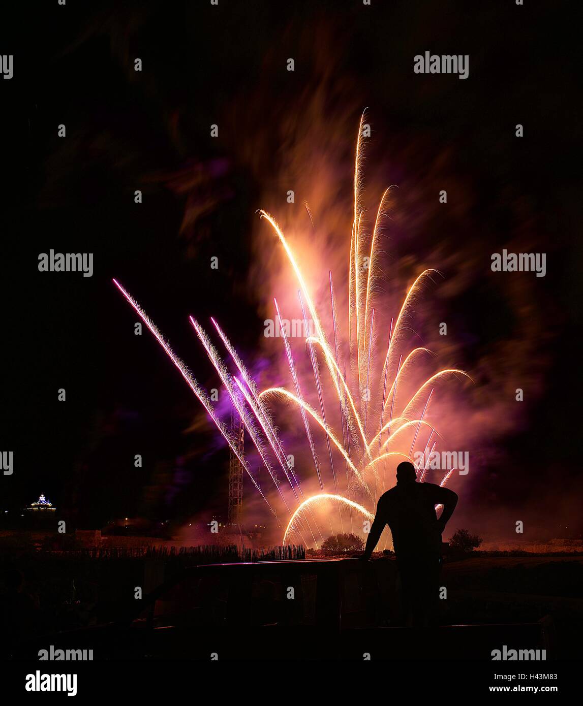 Silhouette of a man looking at firework display hi-res stock ...