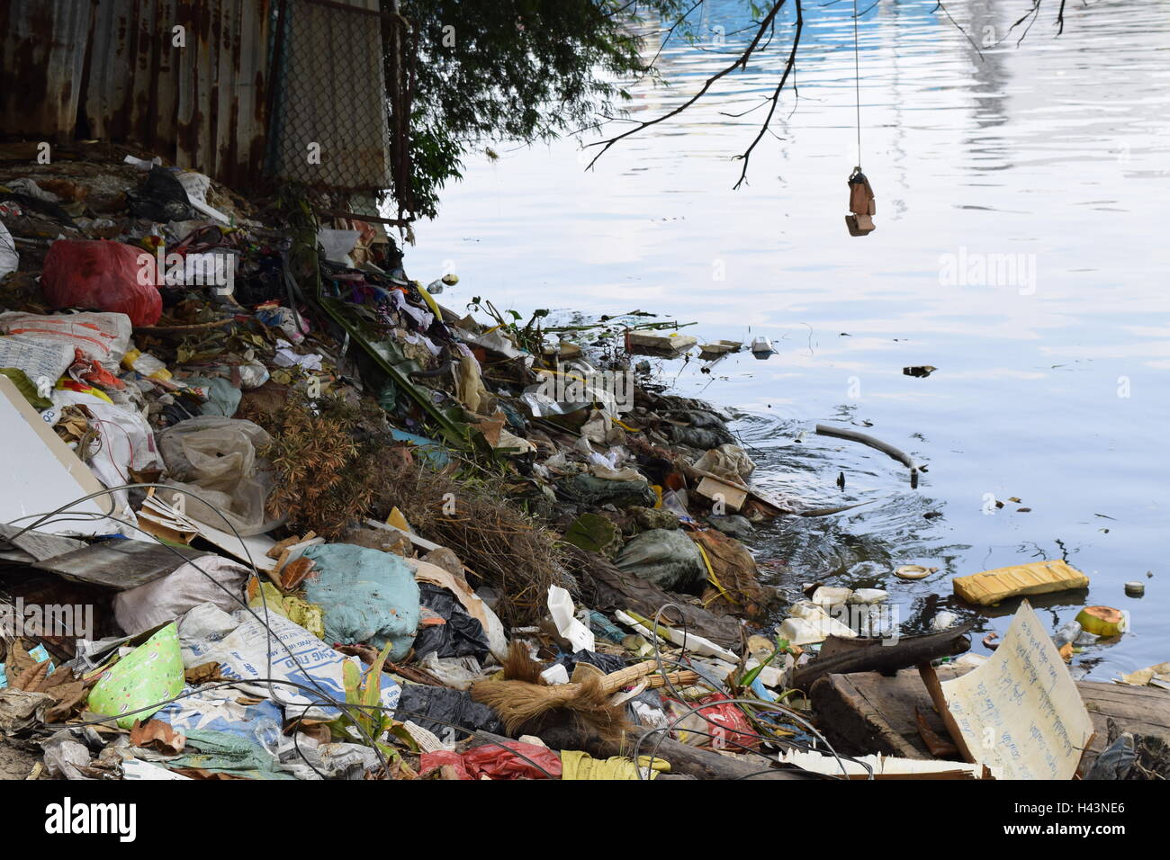 polluted river water with many domestic trash Stock Photo - Alamy