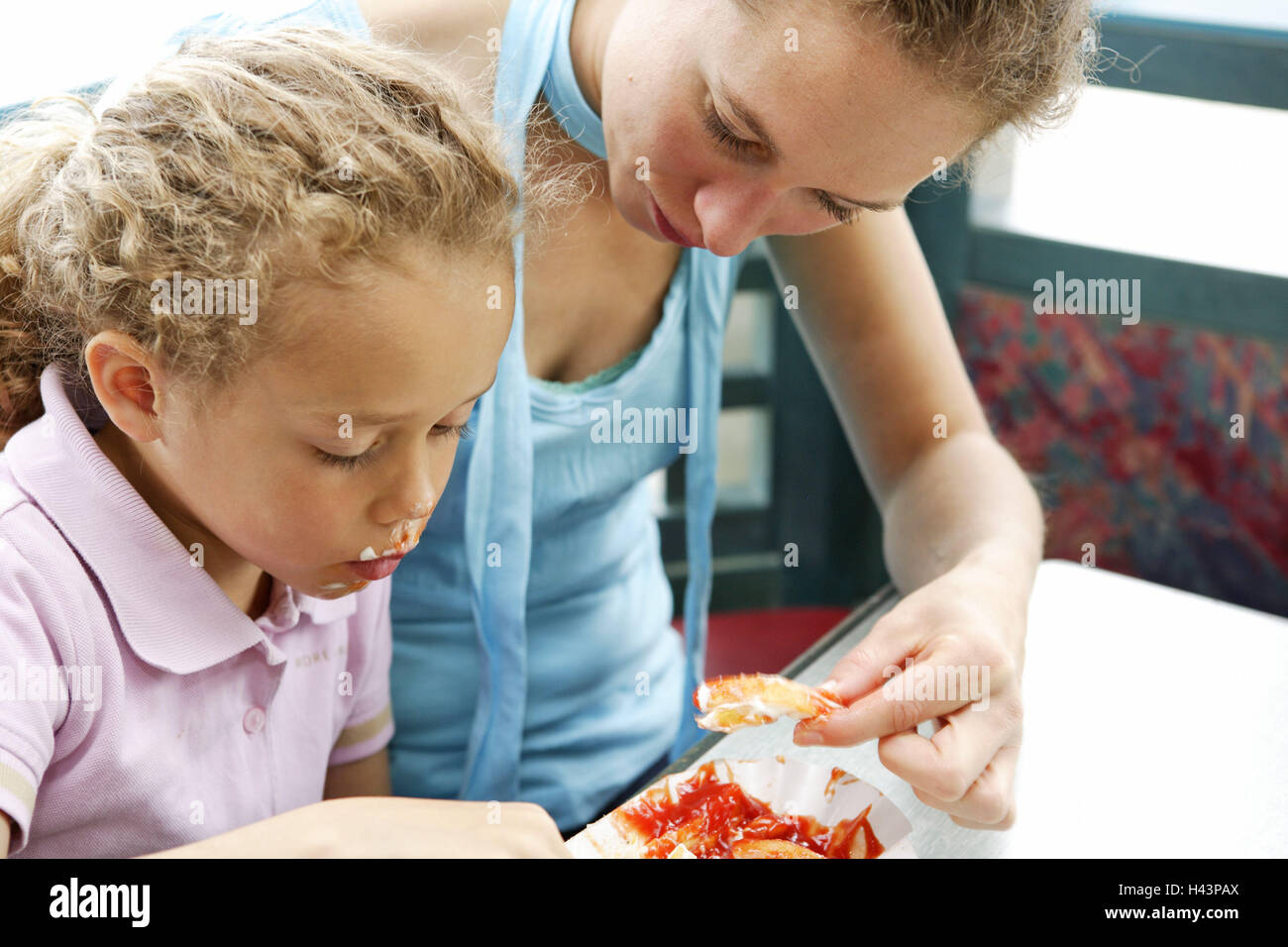 Fast Food, Mother and daughter eating french fries, happy Stock Photo ...