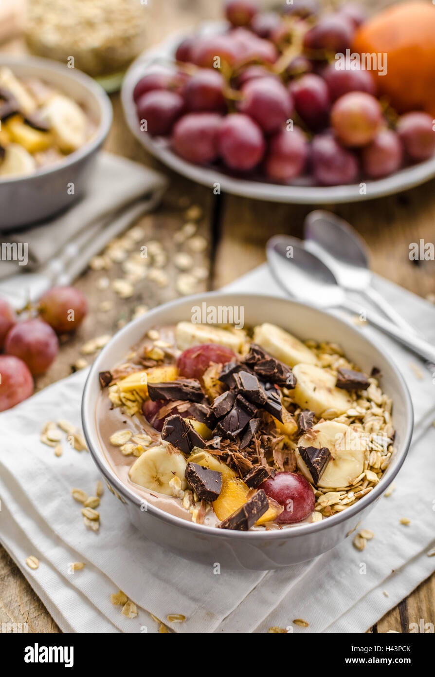 Homemade granola with fruit and chocolate. Fruit - kaki, red grape ...