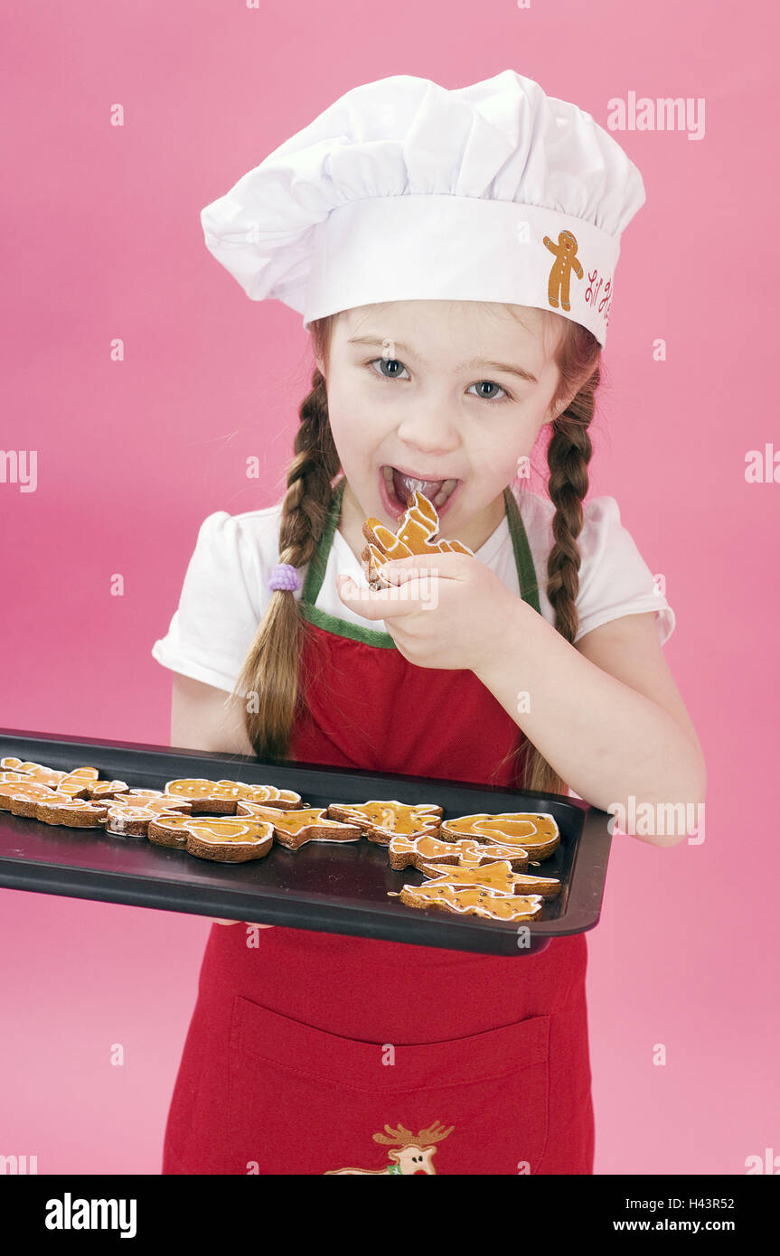 Girls, baking sheet, biscuit eat, studio Stock Photo - Alamy
