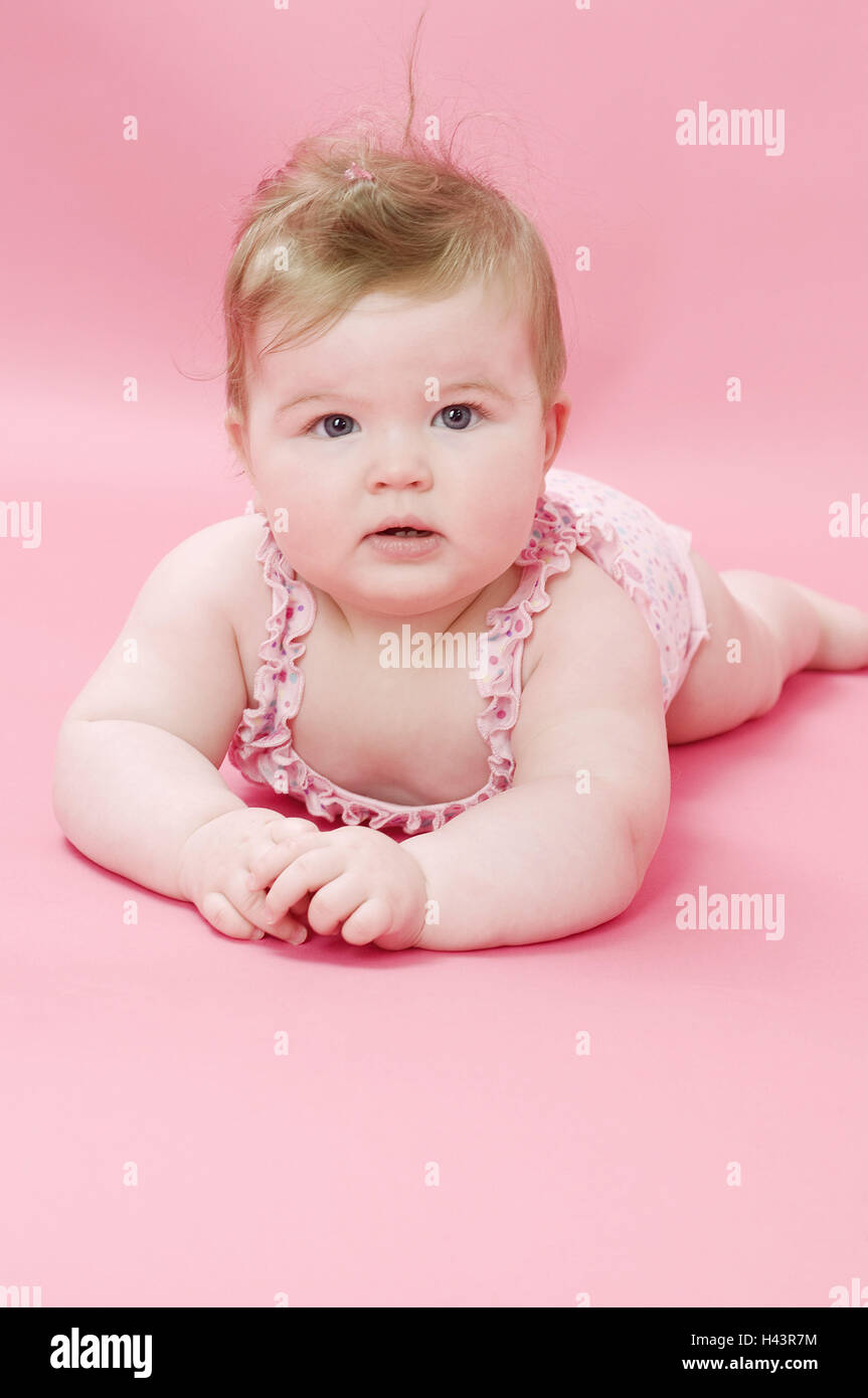 Infant, lying, studio, pink background Stock Photo - Alamy