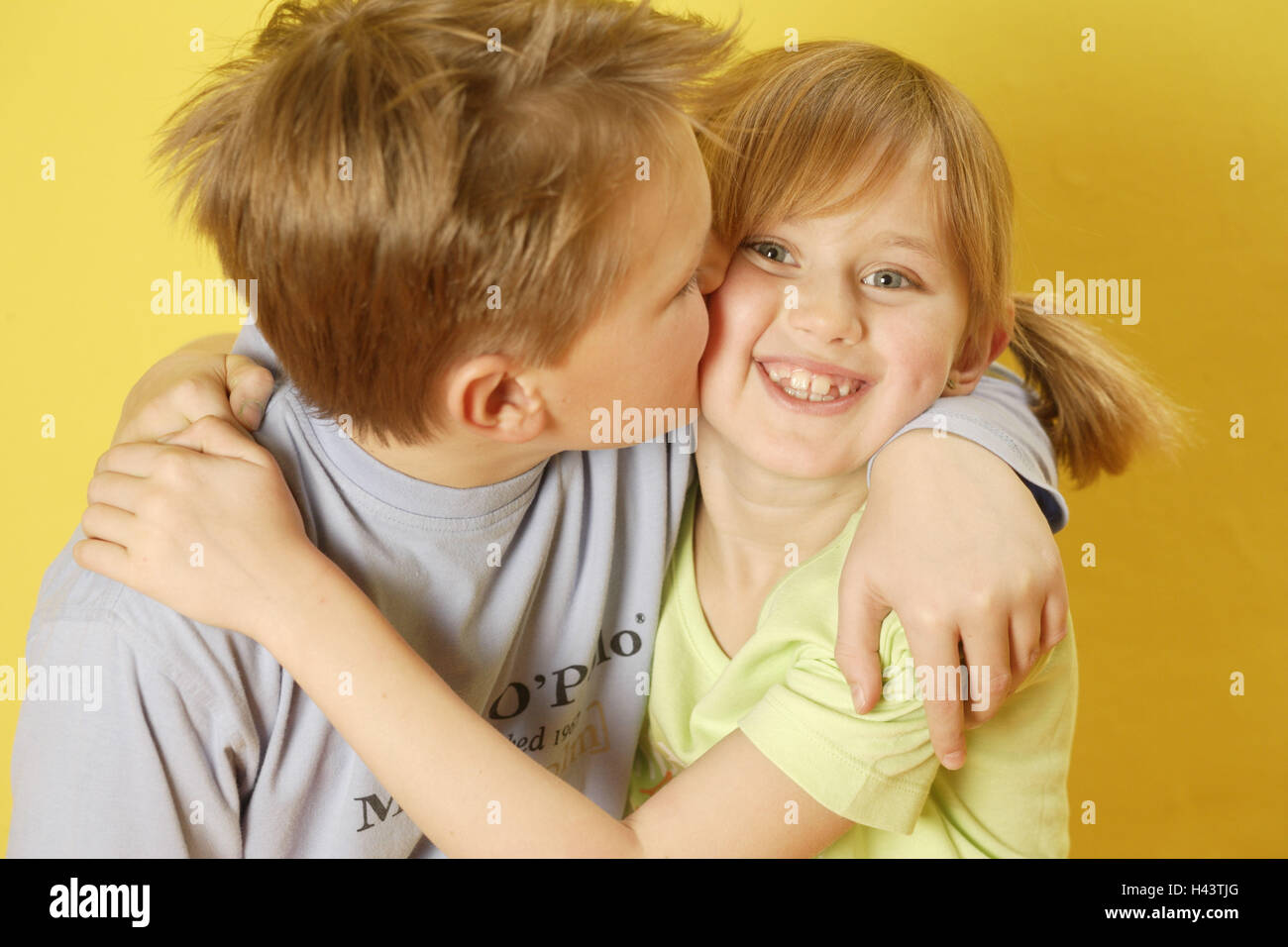 Boy, girl, siblings, kiss, cheek, portrait, curled Stock Photo - Alamy