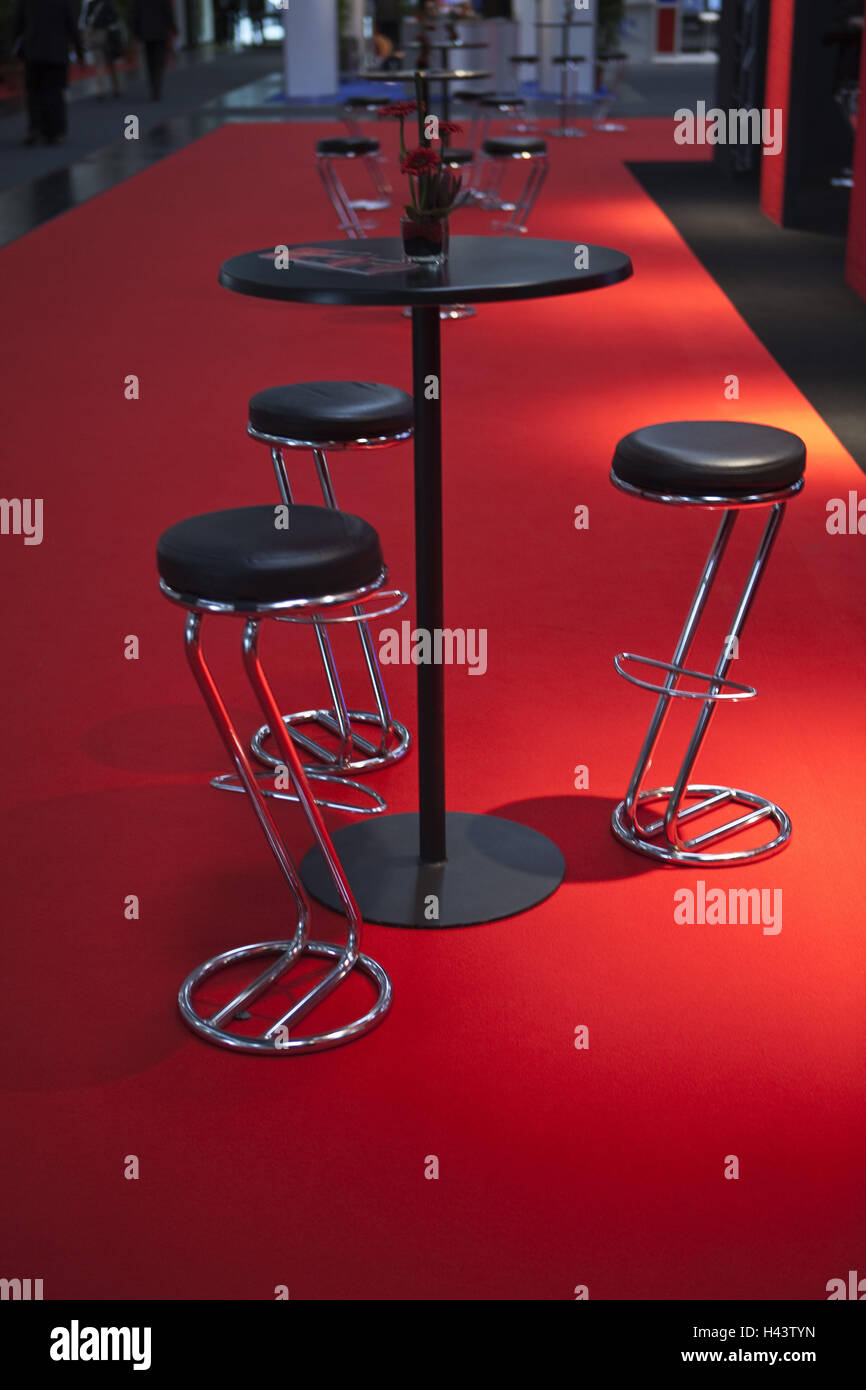 Stool and standing tables on a red carpet Stock Photo - Alamy