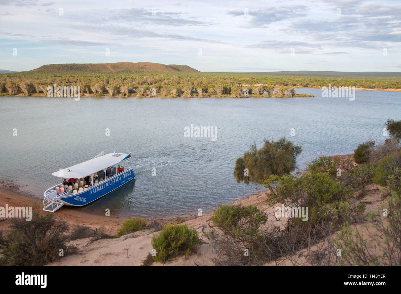 Elevated view over the coastal Murchison River with cruise boat ...