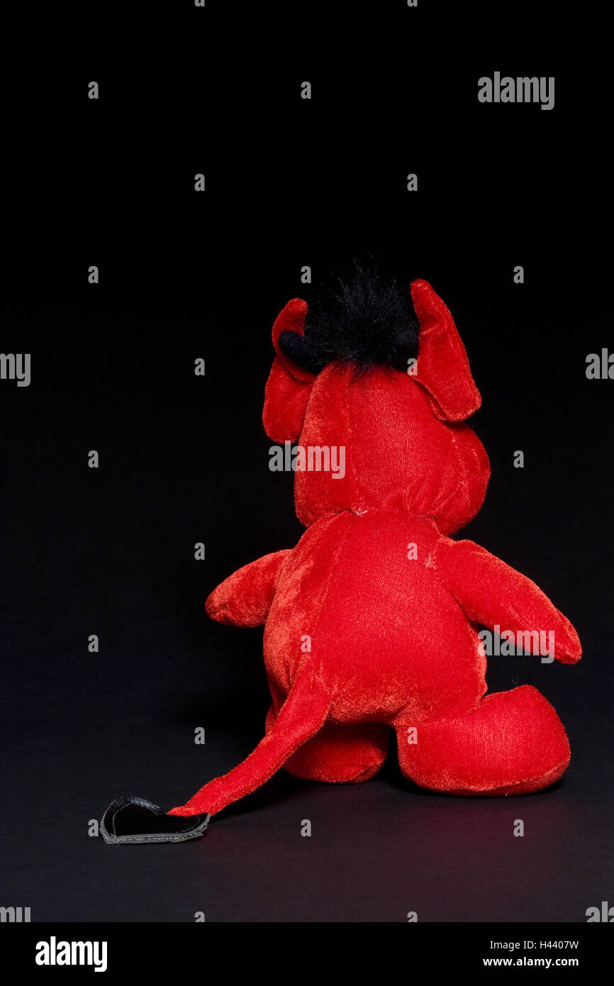 Soft toy, devil, red, from the back, cut out, black background Stock ...