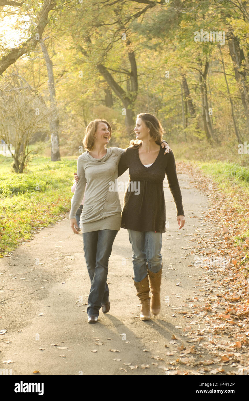 Women, young, arm in arm, autumn walk Stock Photo - Alamy