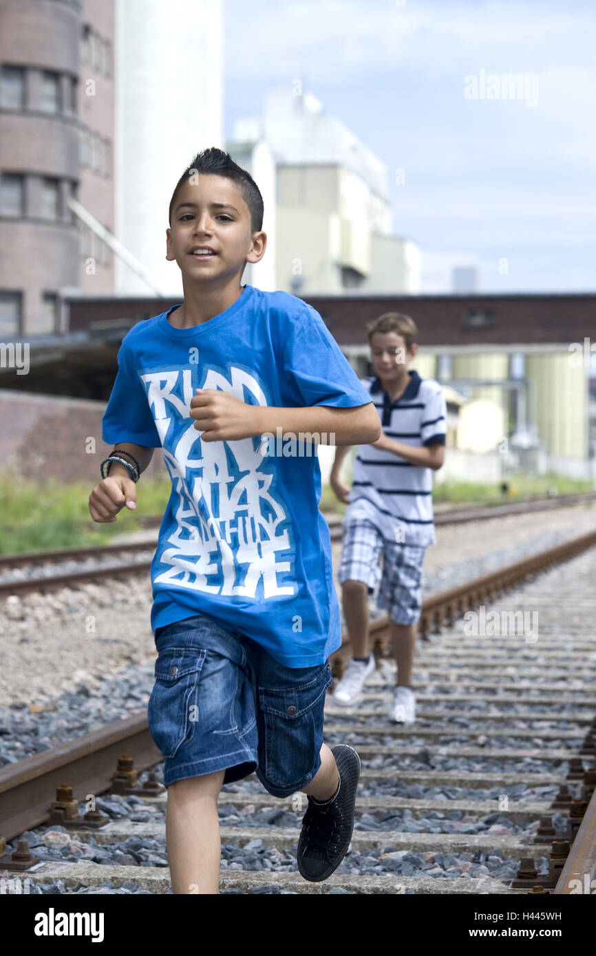 two boys run in railroad Stock Photo - Alamy