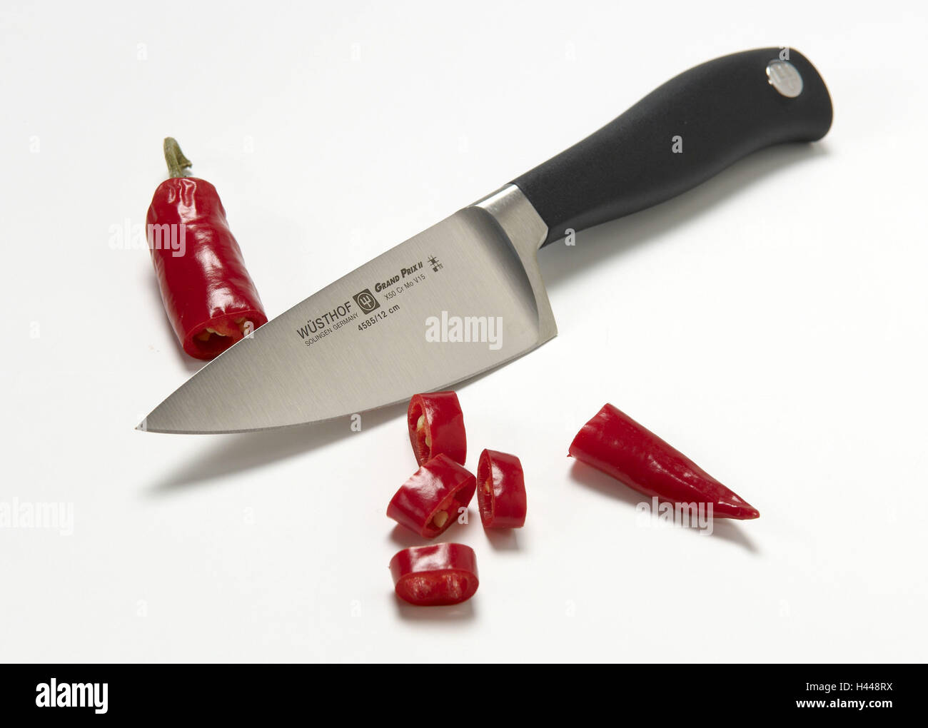 Kitchen knife, chilli pod, chopping Stock Photo - Alamy
