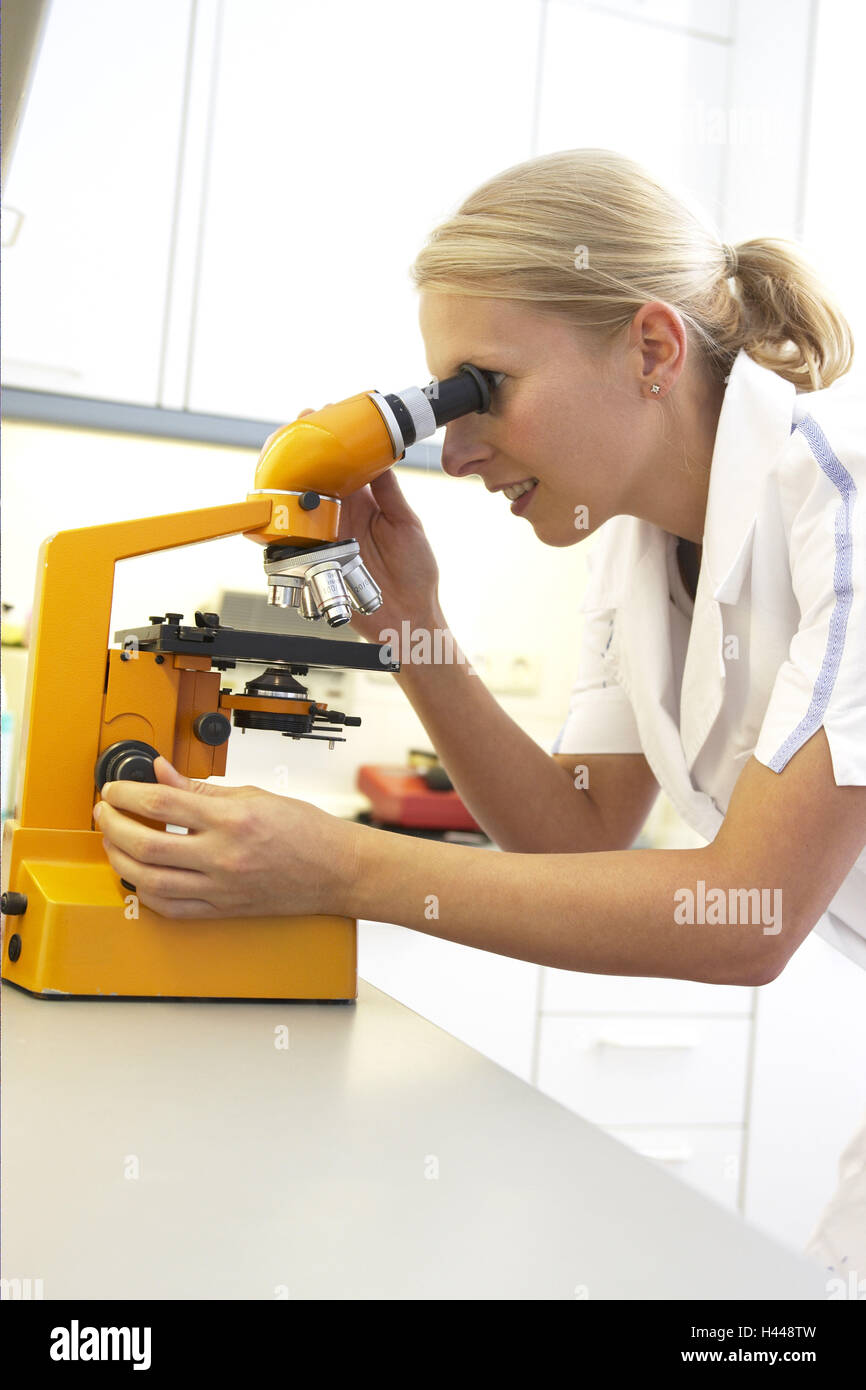 Woman, young, view microscope, tread, detail, model released Stock ...