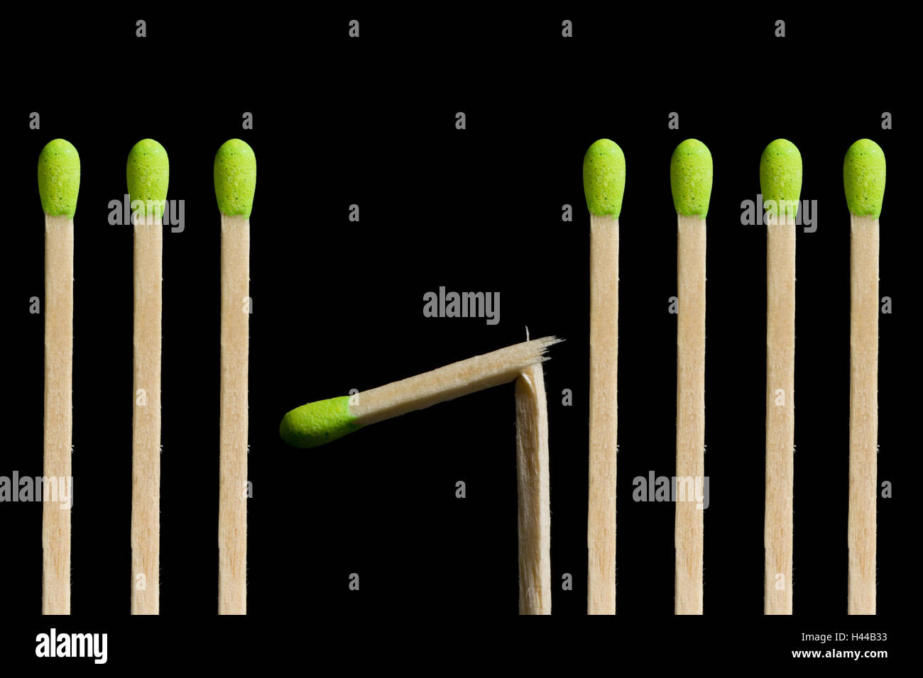 Matches, green, lined up, one glum, cut out, background black Stock ...