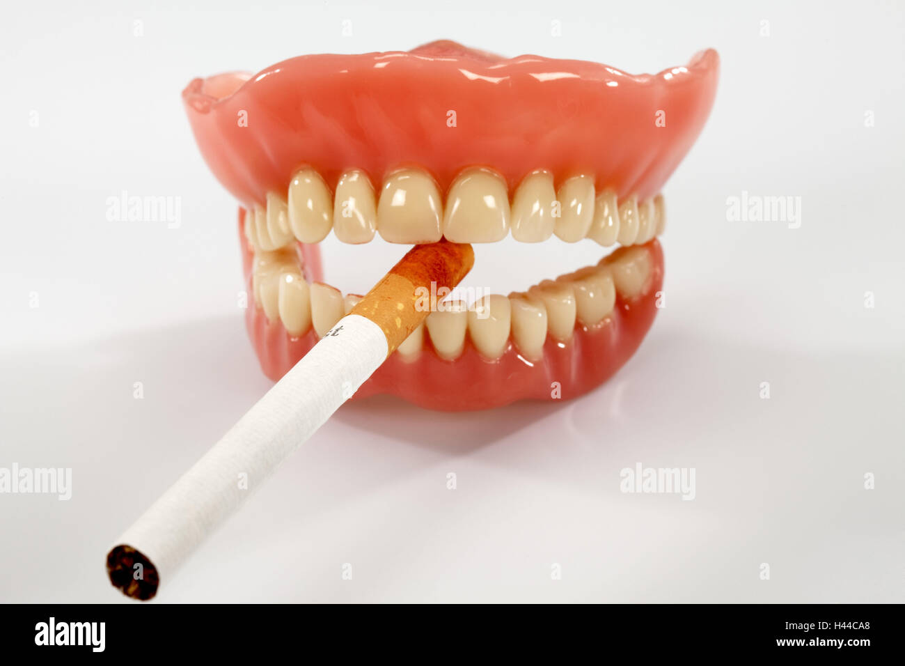 Bite prosthesis, cigarette Stock Photo - Alamy