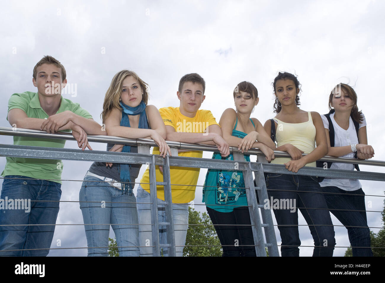 six young people, railings, stand, view camera Stock Photo - Alamy