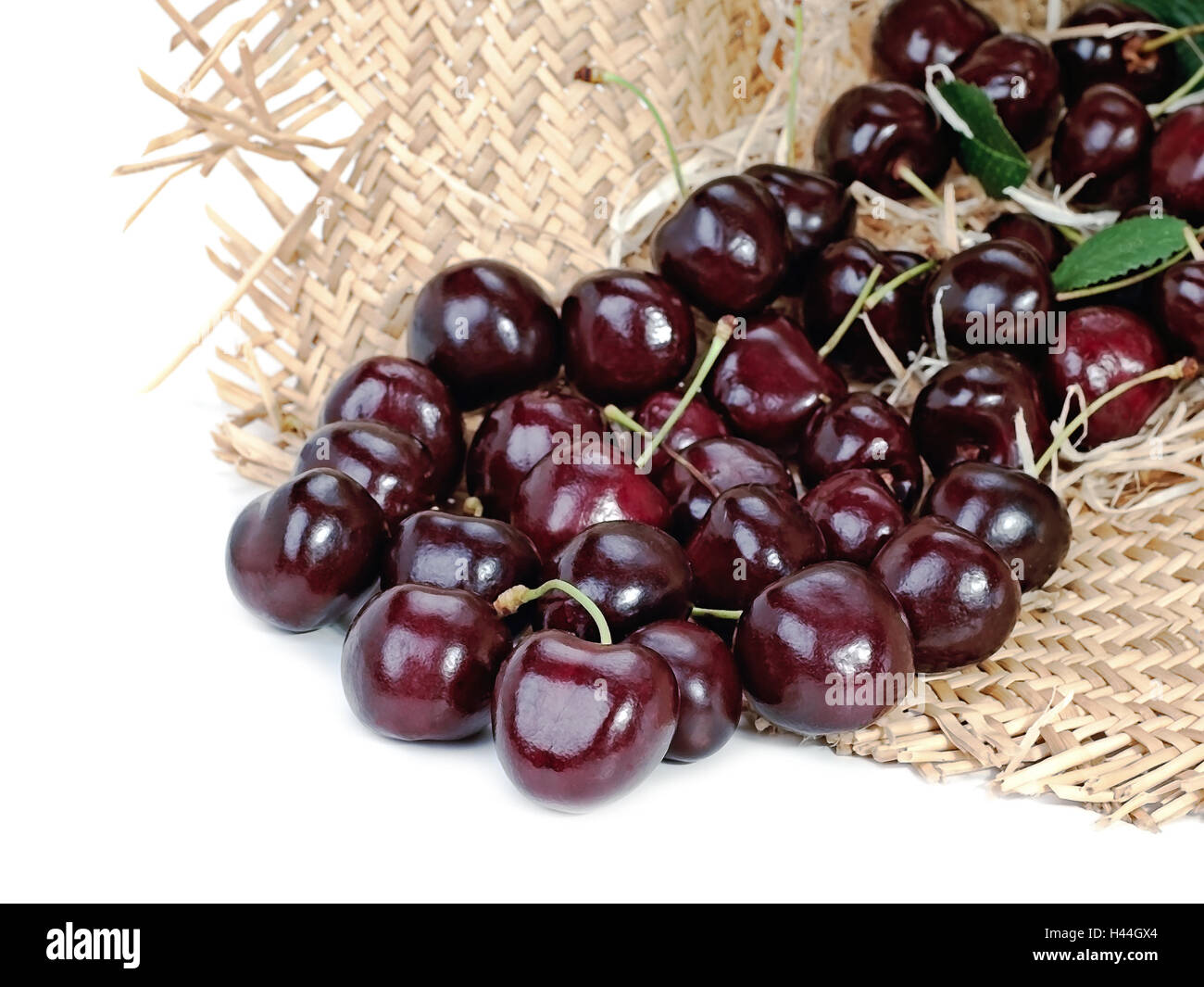 Sweet cherry in a straw hat isolated on white background. Closeup Stock ...