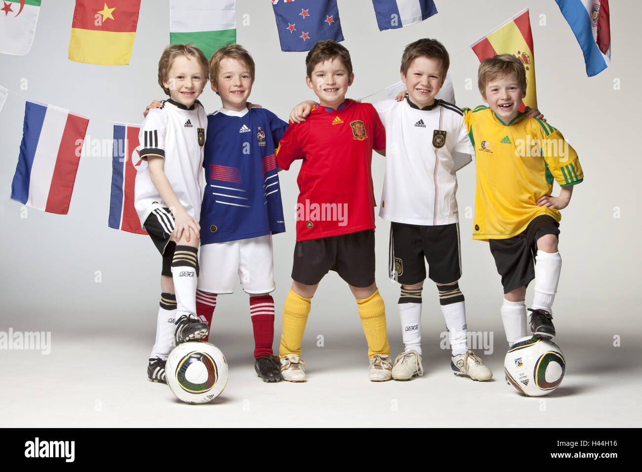 Boys, five, football jerseys, arm in arm, group picture, international ...