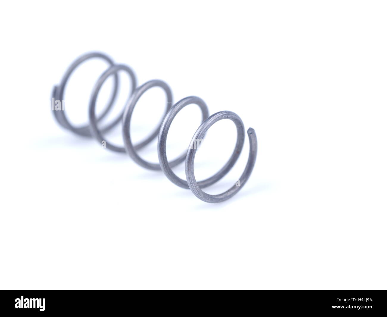 steel spring on white background Stock Photo - Alamy