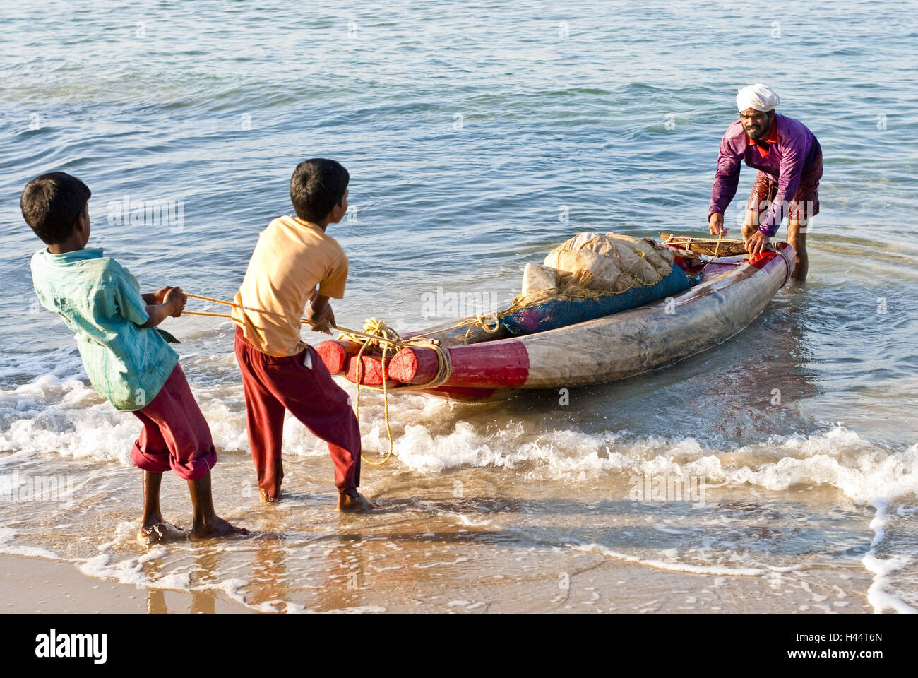 Fishermen, man, children, boat, sea, beach, drag Stock Photo - Alamy
