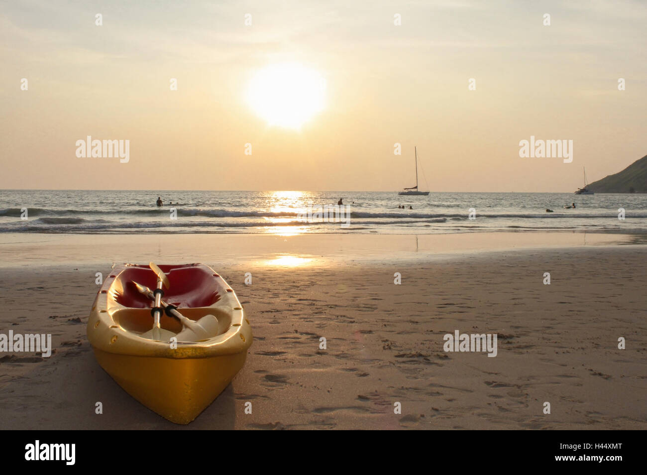 a kayak canoe boat on the beach during sunset Stock Photo - Alamy