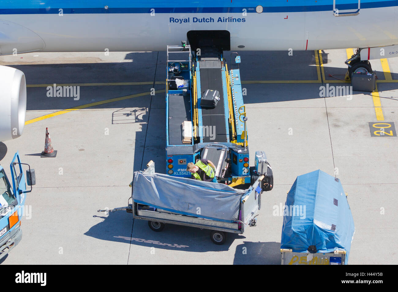 AMSTERDAM, NETHERLANDS - AUGUST 17, 2016: Loading luggage in airplane ...