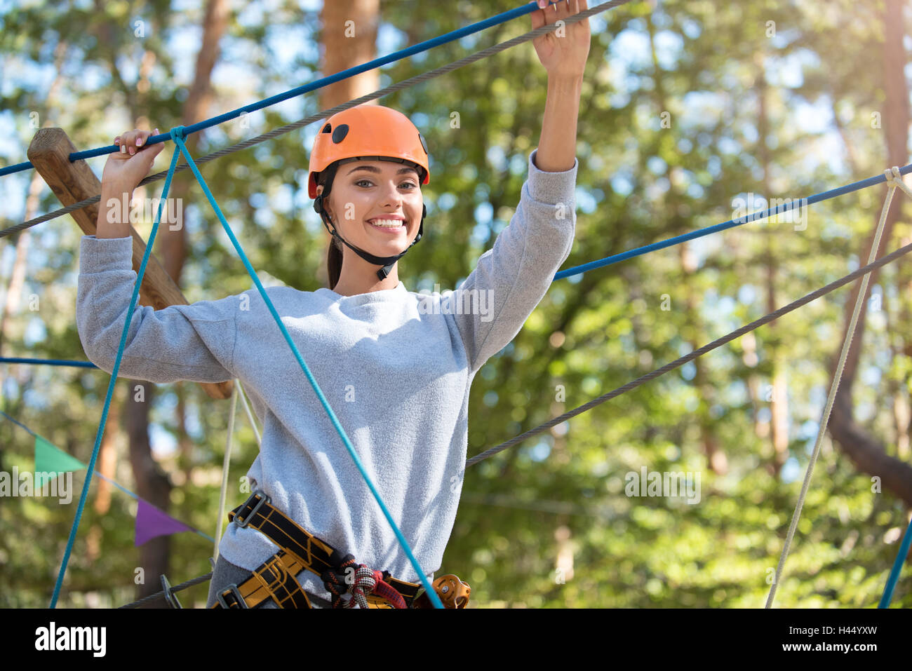 Cute happy woman enjoying her climb Stock Photo - Alamy
