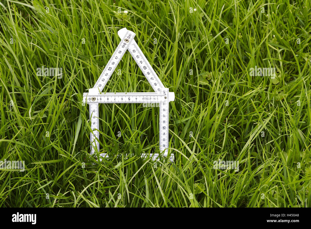 Meadow, folding ruler, house form Stock Photo - Alamy