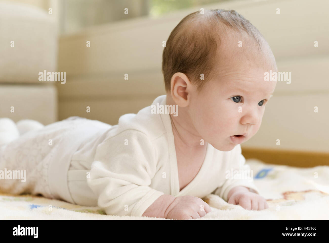 Baby lies on abdomen Stock Photo - Alamy