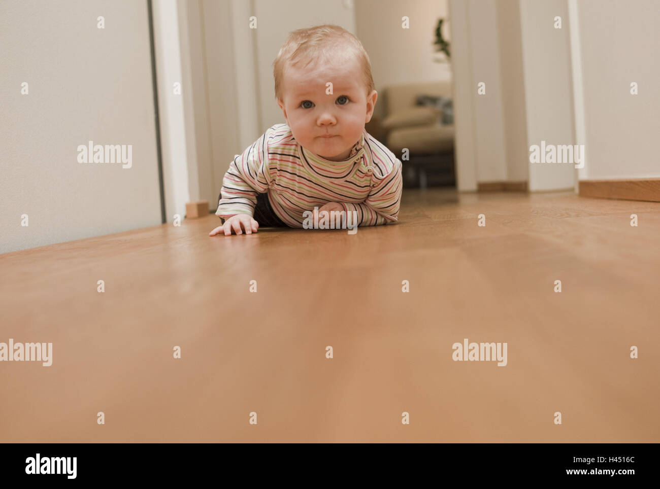 Baby creeps on floor Stock Photo - Alamy