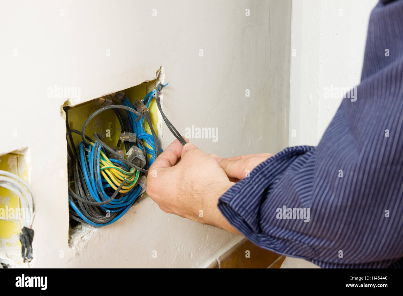 electrician at work in a house fitting a plug Stock Photo - Alamy