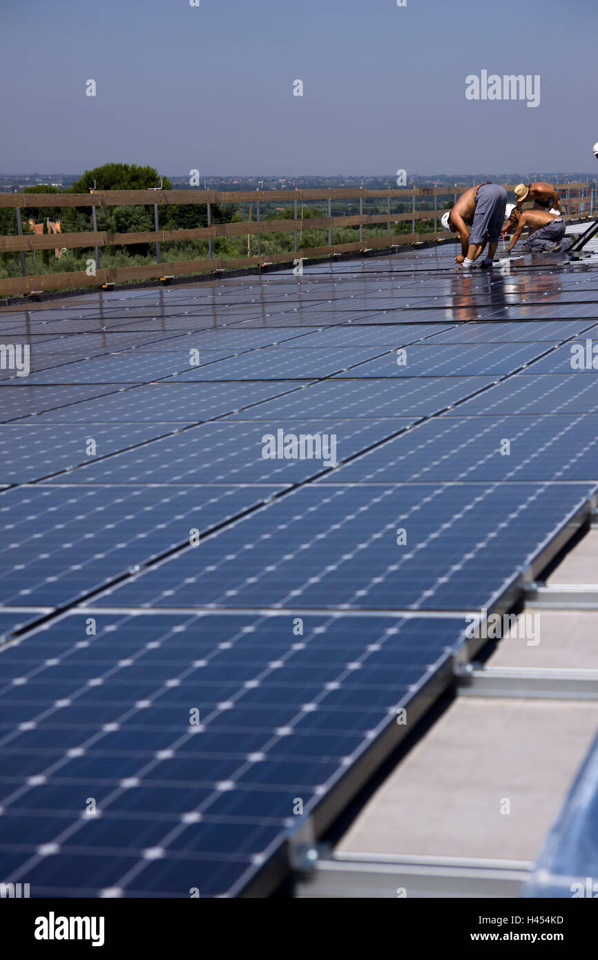 skilled worker fitting a photovoltaic plant on a roof Stock Photo - Alamy