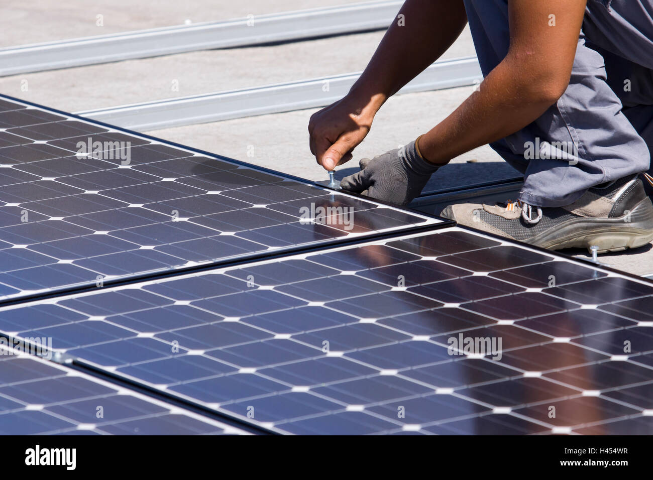 skilled worker fitting a photovoltaic panel on a roof Stock Photo - Alamy