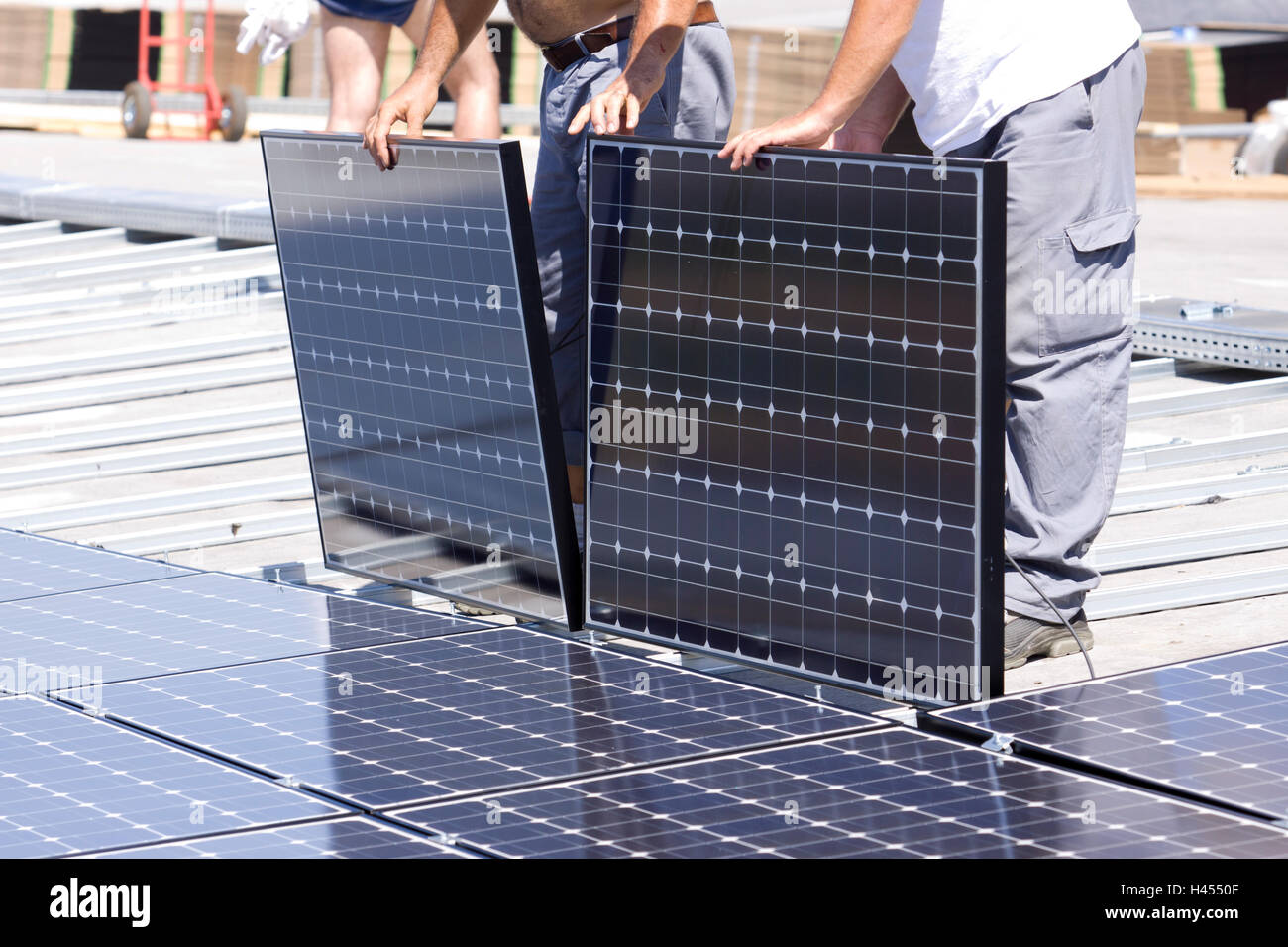 skilled worker fitting a photovoltaic panel on a roof Stock Photo - Alamy