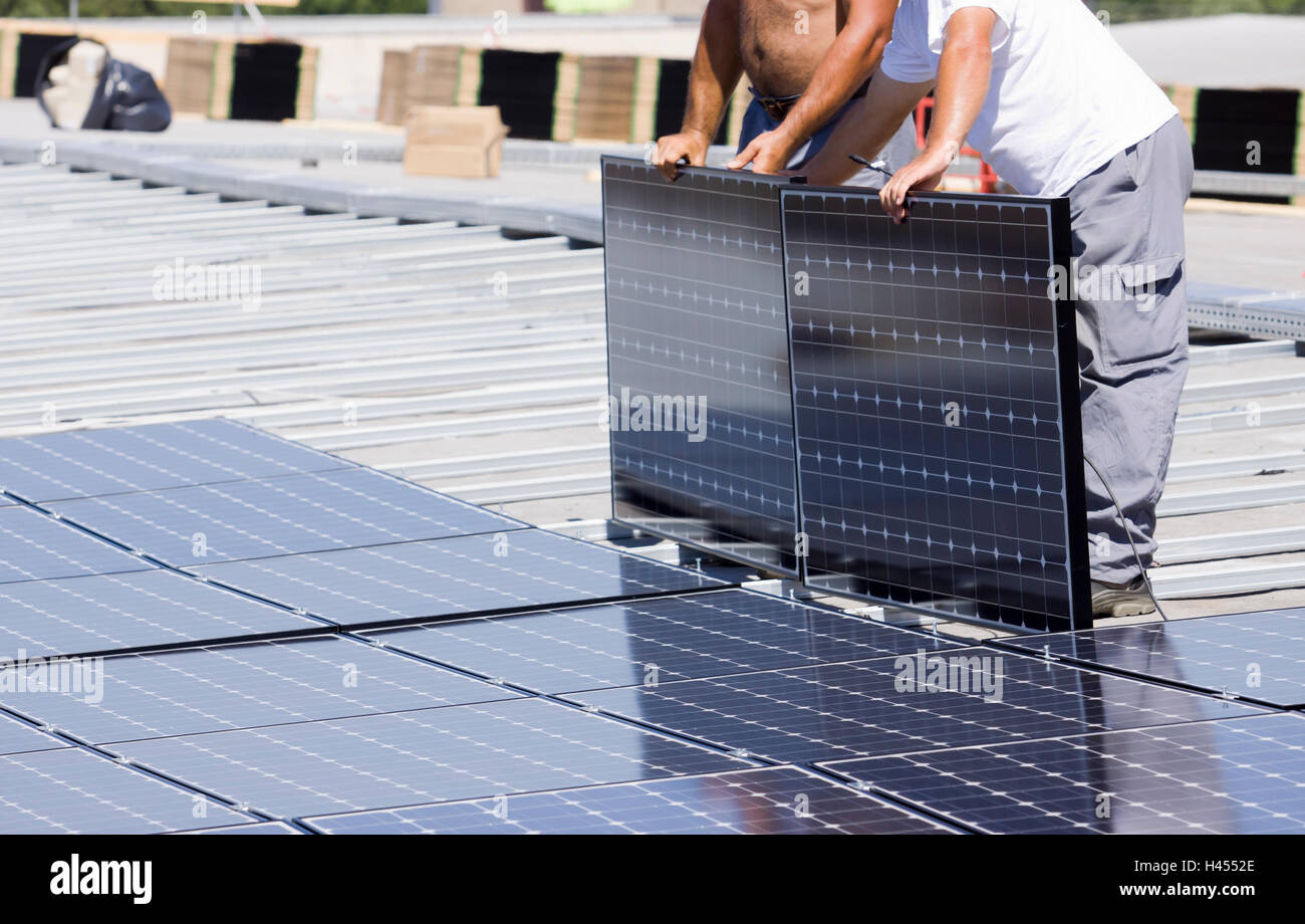 skilled worker fitting a photovoltaic panel on a roof Stock Photo - Alamy
