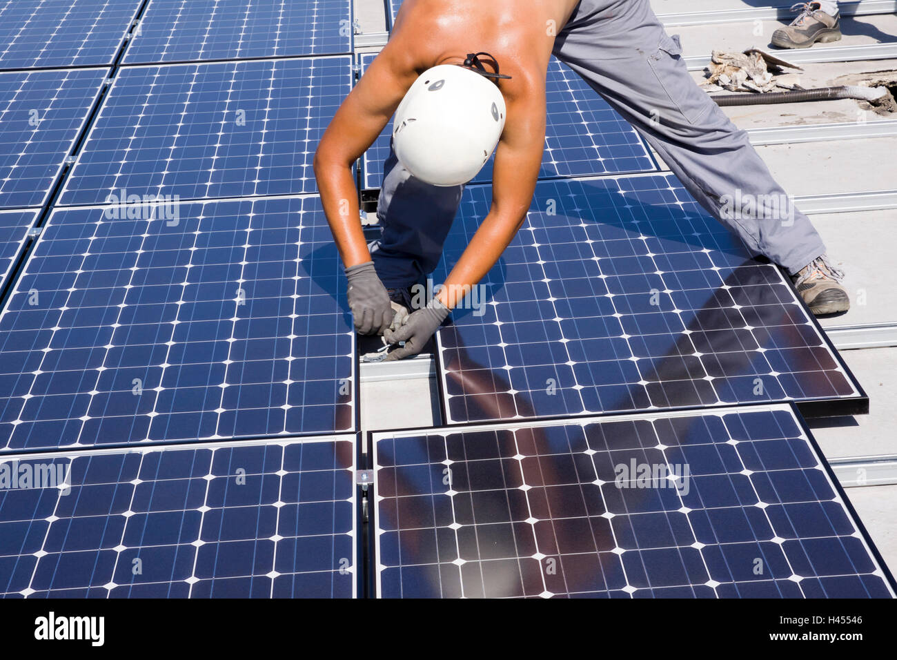 skilled worker fitting a photovoltaic plant on a roof Stock Photo - Alamy
