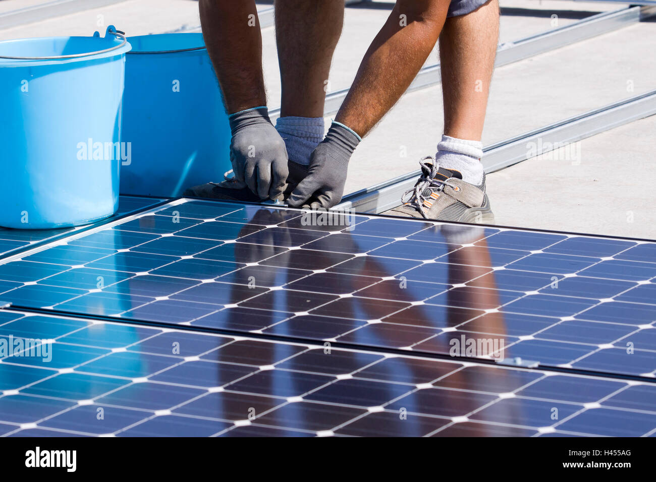skilled worker fitting a photovoltaic panel on a roof Stock Photo - Alamy