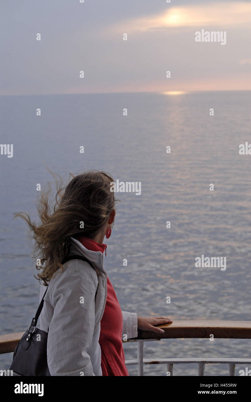 Woman, rail, ship, back view, dusk Stock Photo - Alamy