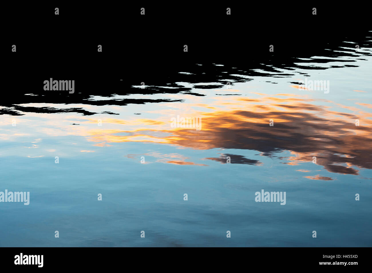 Water ripples and cloud reflections at sunrise in Scotland Stock Photo ...