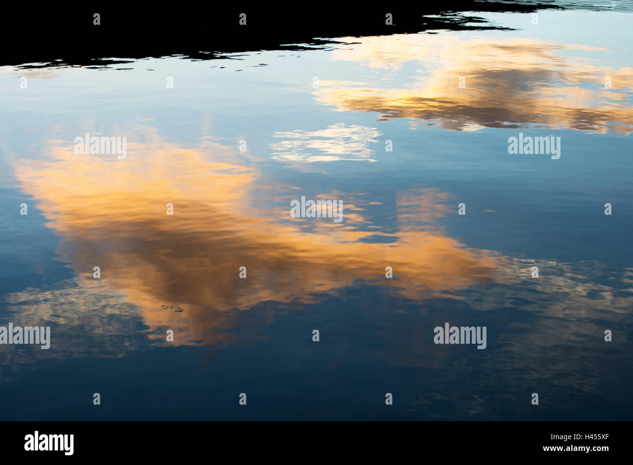 Water ripples and cloud reflections at sunrise in Scotland Stock Photo ...