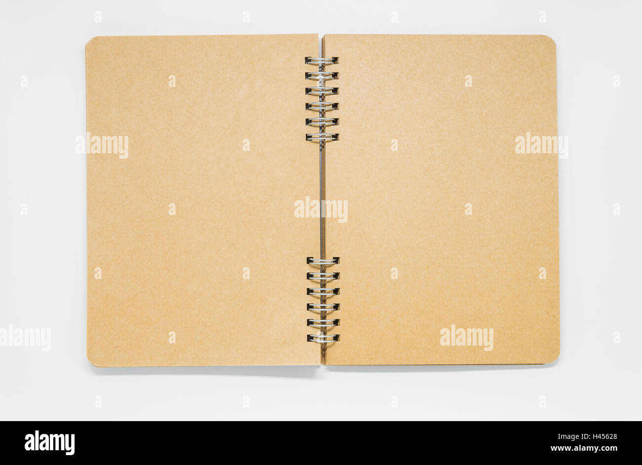 Opened Brown plain notebook with ring on white background and selective ...