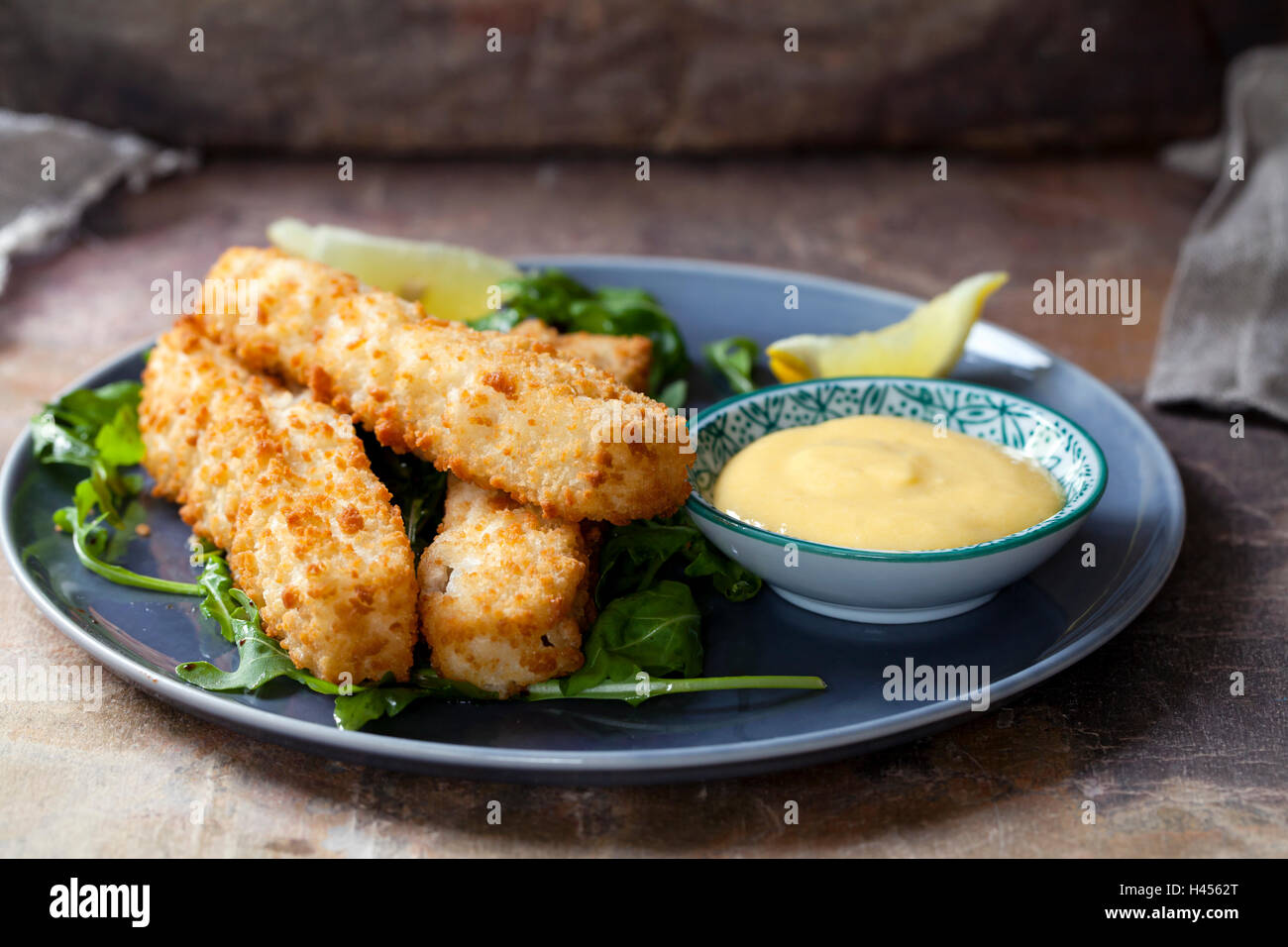 Fish fingers with homemade aioli and rocket salad Stock Photo - Alamy