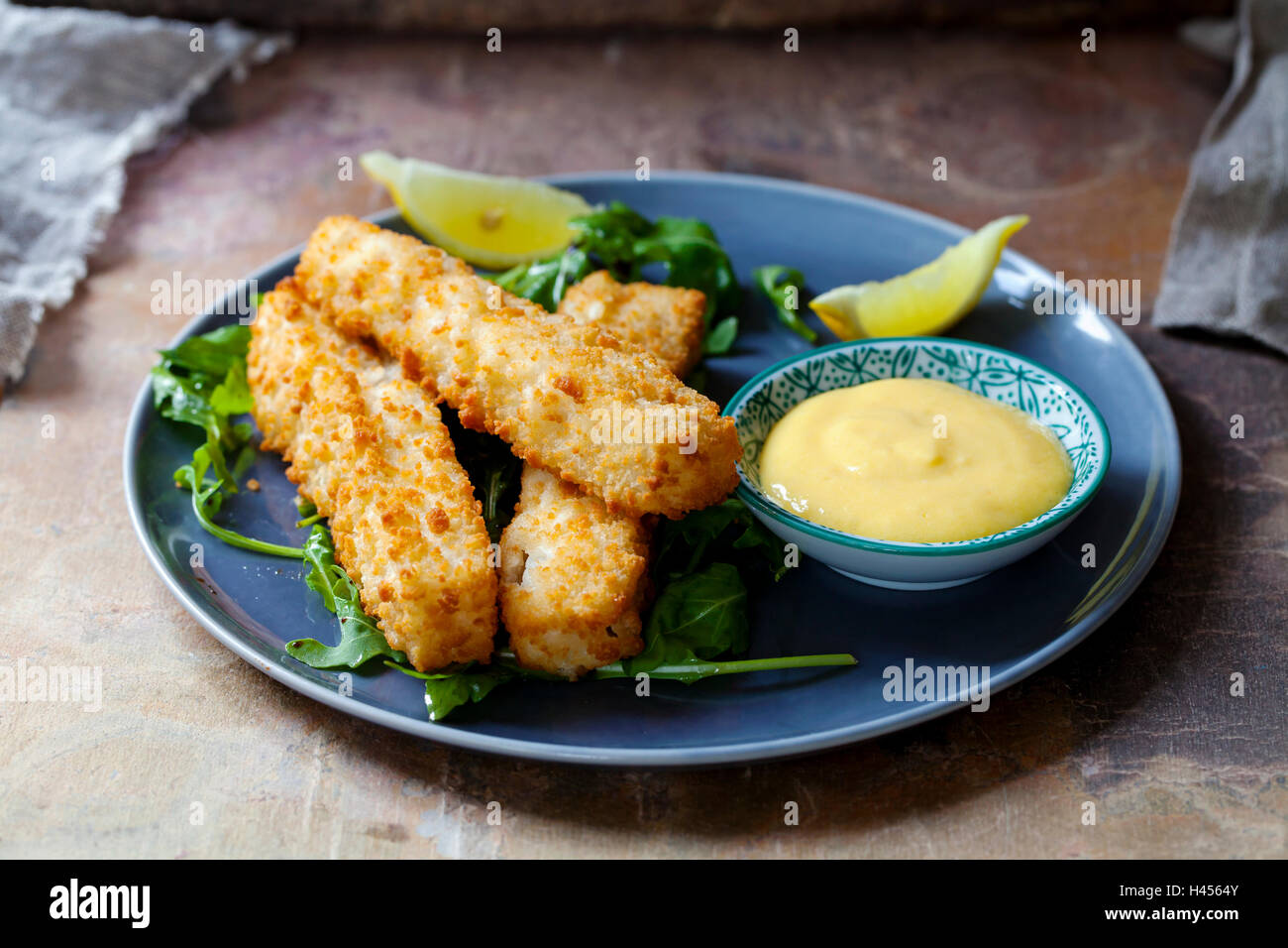Fish fingers with homemade aioli and rocket salad Stock Photo - Alamy