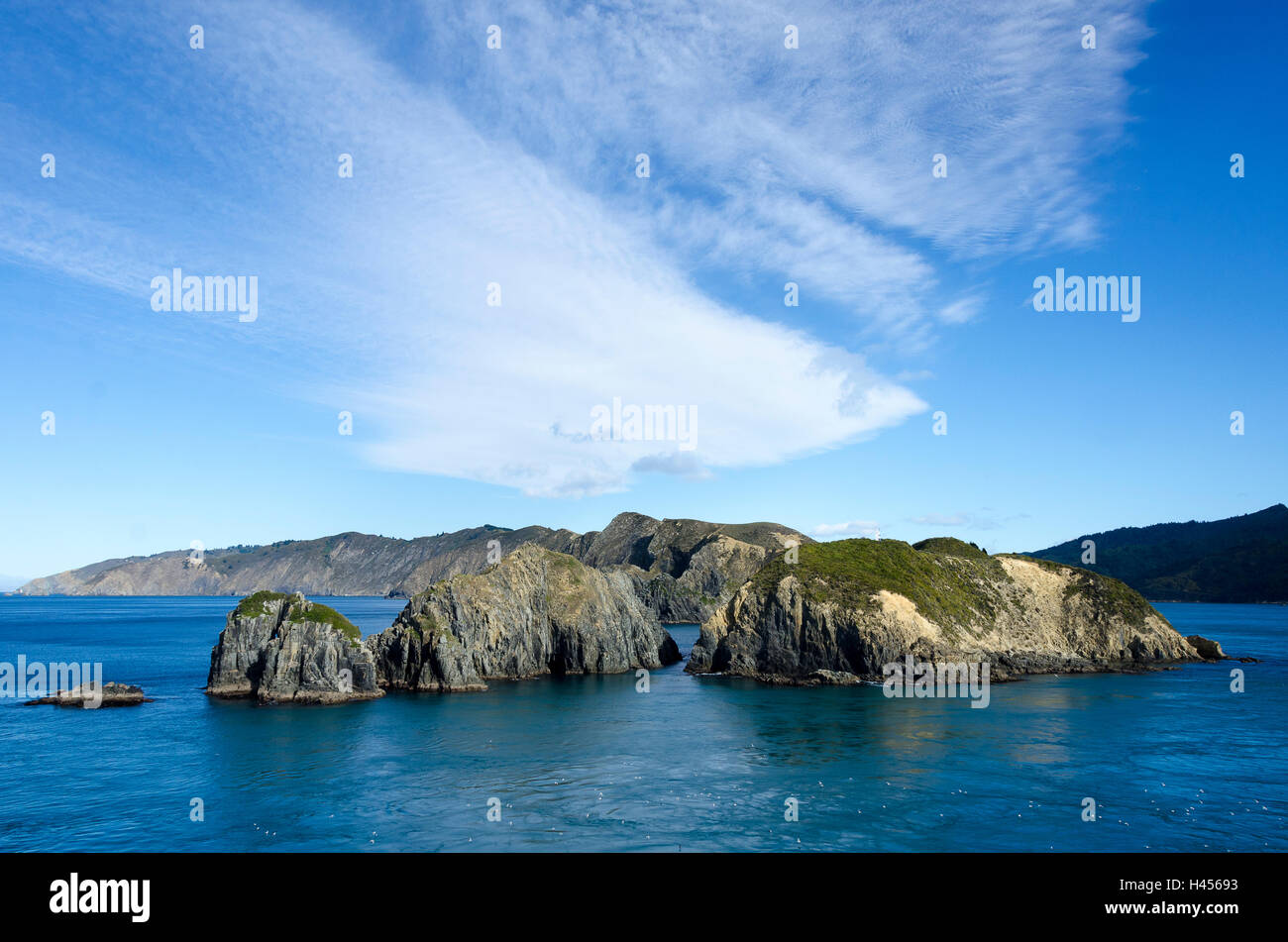 Rocky coast, cliffs and small islands at entrance to Tory Channel ...