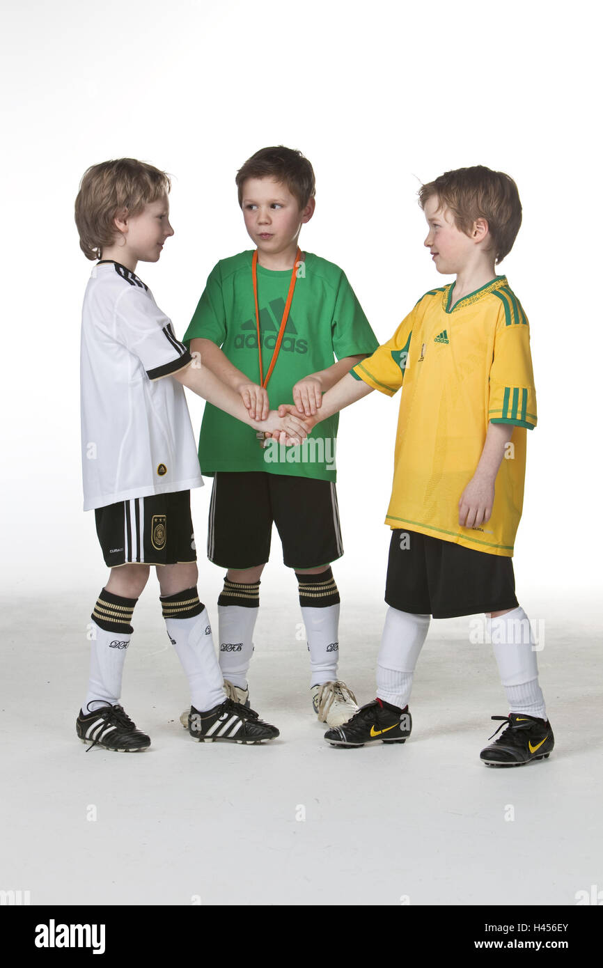 Boys, three football jerseys, slap Stock Photo - Alamy